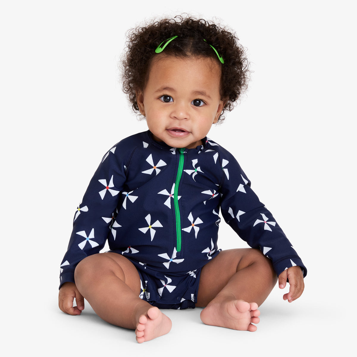 Baby one-piece rash guard in rainbow pinwheels | Primary.com